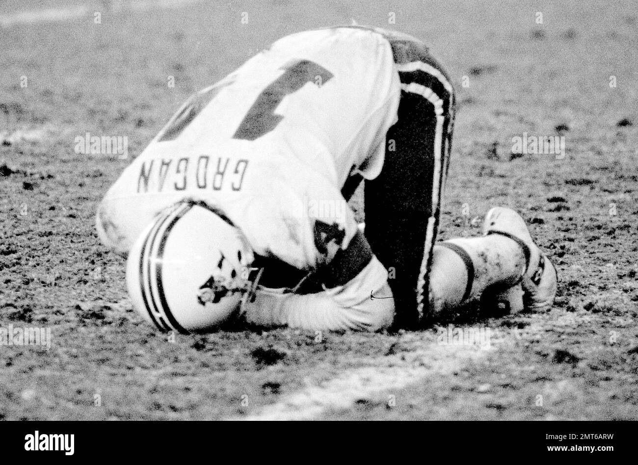 New England Patriots quarterback Steve Grogan buries his face in his ...