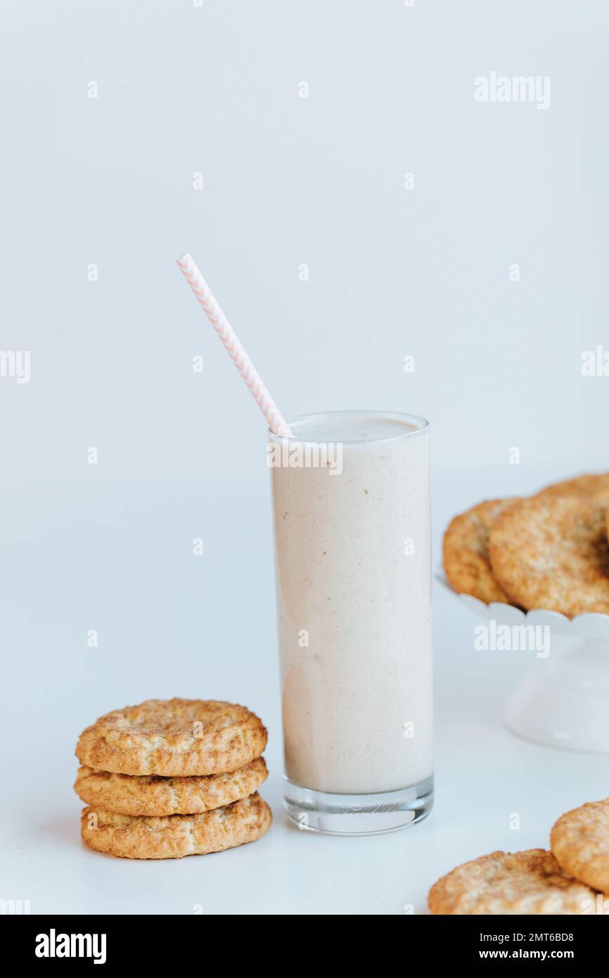 A vertical of the fresh milkshake with cookies isolated on the empty ...