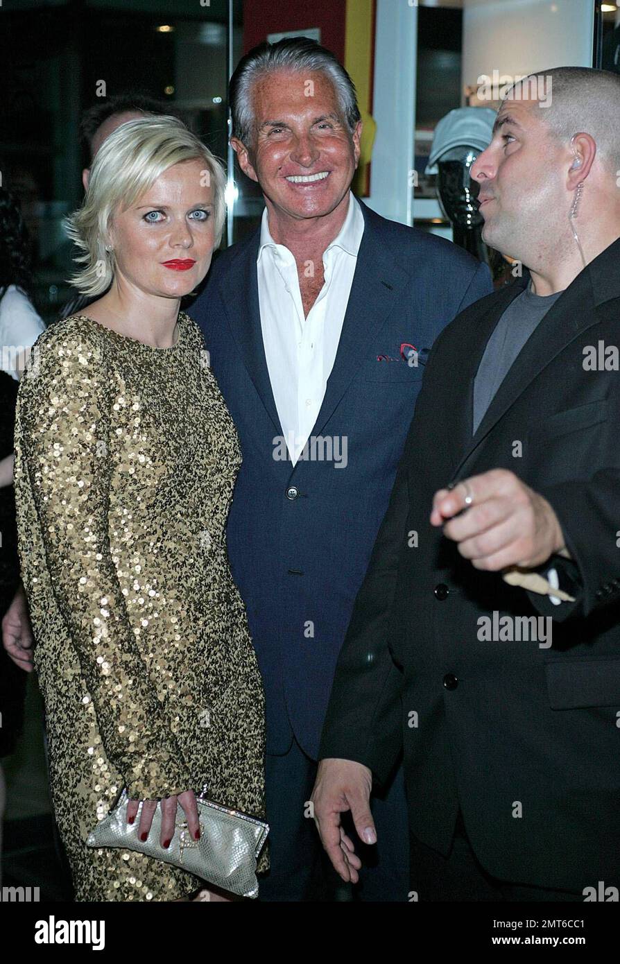 George Hamilton (C) and guest wait to pass through security on the way ...