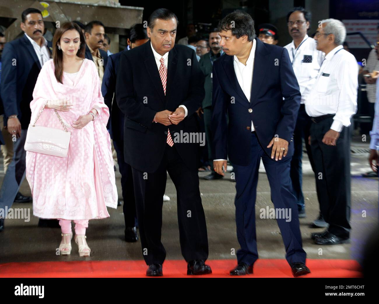 Chairman of Reliance Industries Mukesh Ambani, center, arrives with his wife Nita, left, for the ...