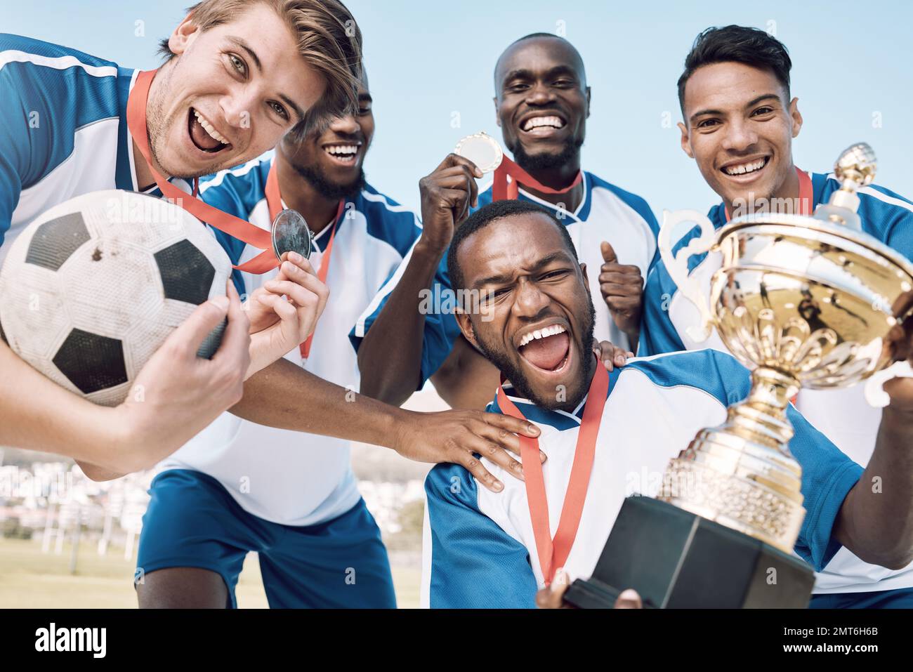 Soccer, trophy and men team winning portrait at sports competition or ...