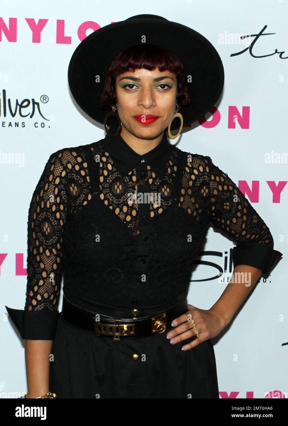DJ Rashida poses for photographers on the red carpet at NYLON ...