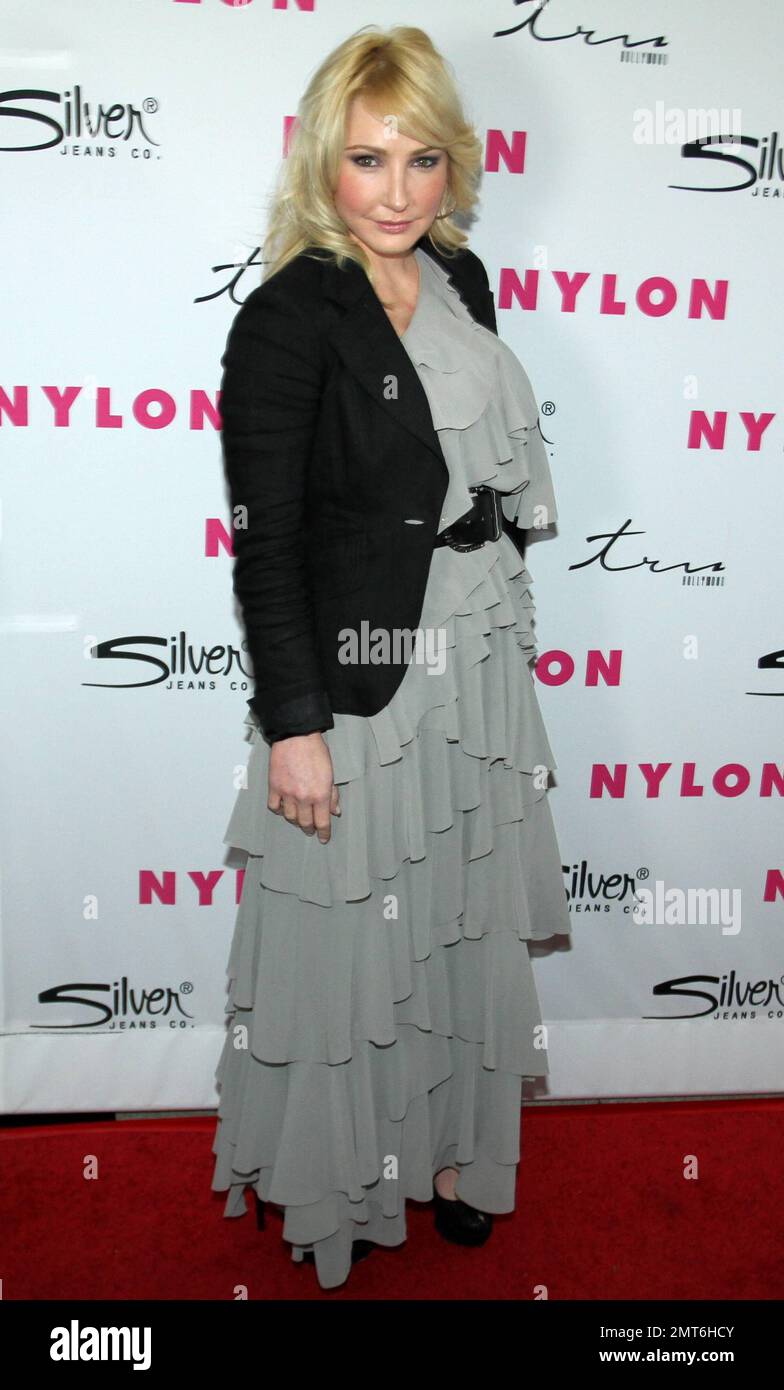 Designer Nikki Lund poses for photographers on the red carpet at NYLON ...