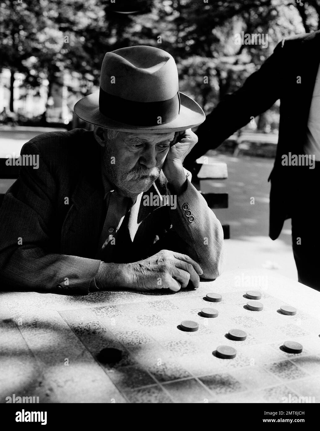 A serene New Yorker quietly ponders his next move in a checkers game in ...