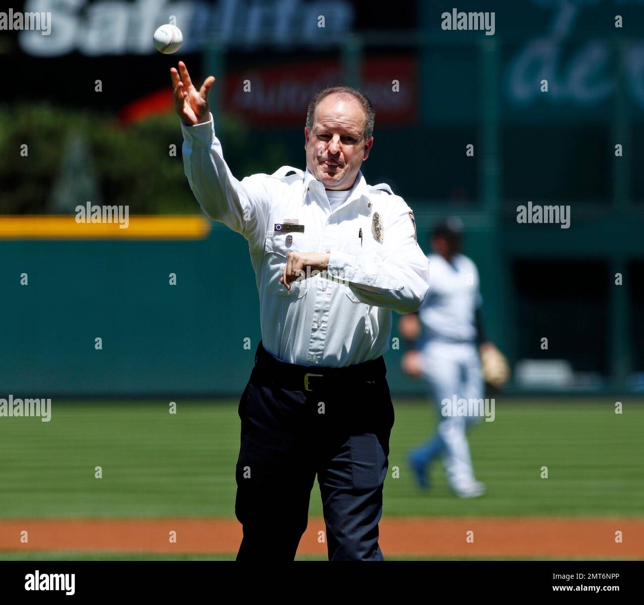 Denver Fire Department Chief Eric Tade throws out the ceremonial first ...