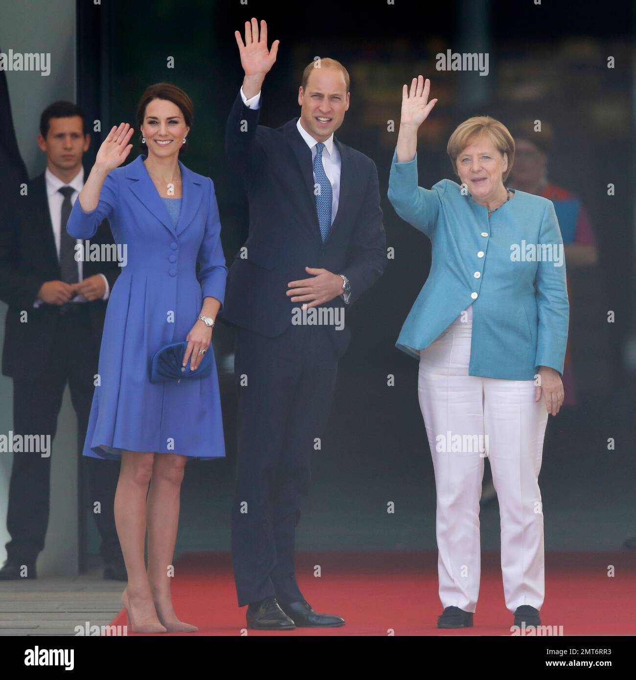 German Chancellor Angela Merkel, right, waves besides Britain's Prince ...