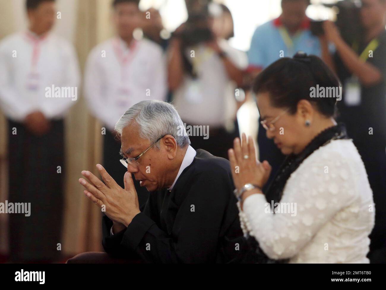 Myanmar President Htin Kyaw, left, and his wife Su Su Lwin pay respect ...