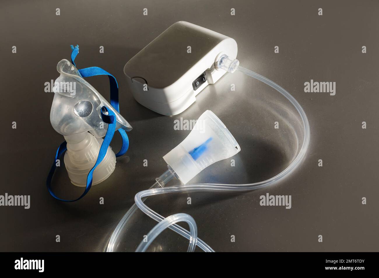 Compressor nebulizer with mask on table Stock Photo - Alamy