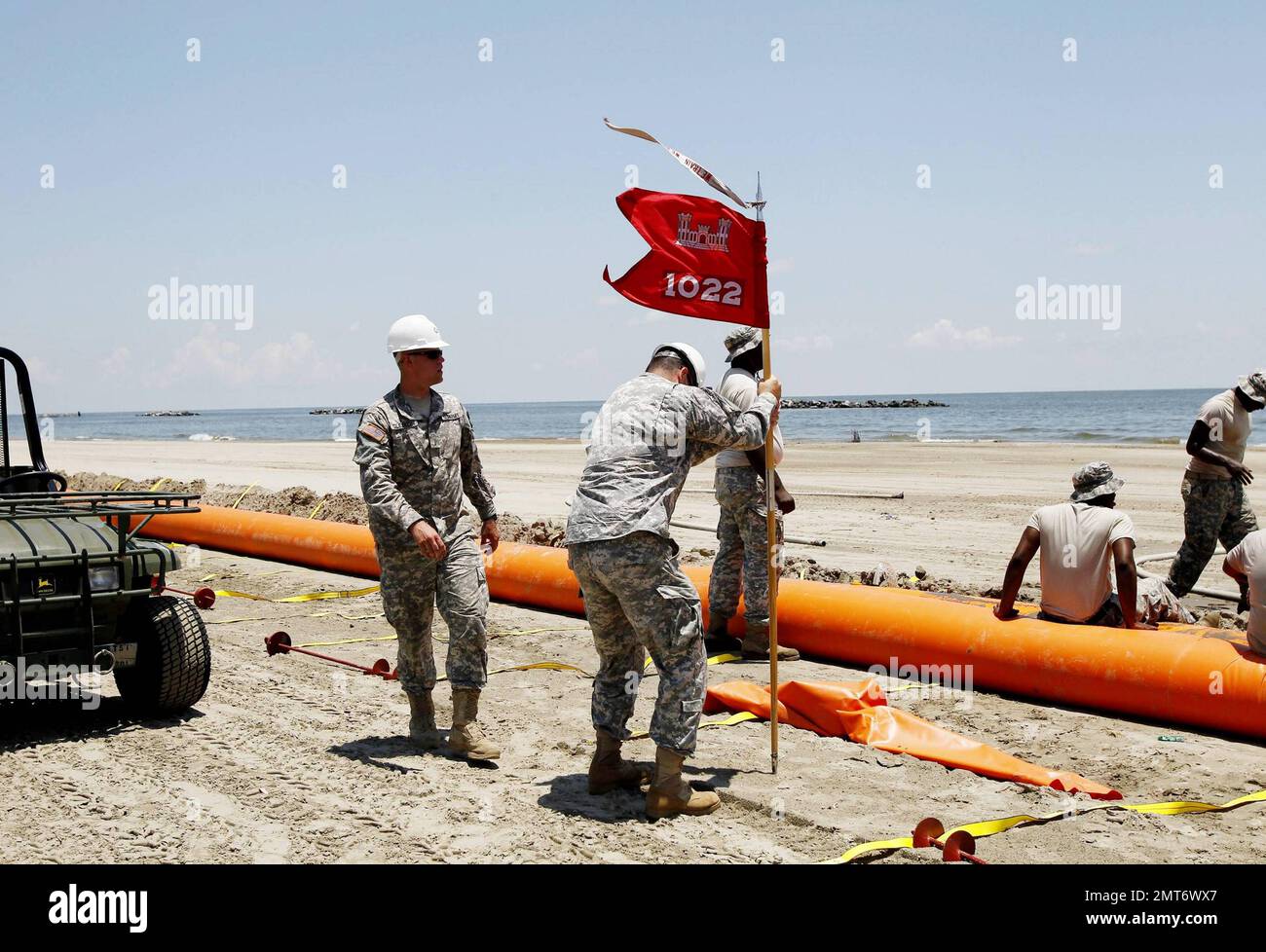 Inflatable barricades are installed by the National Guard on the beach ...