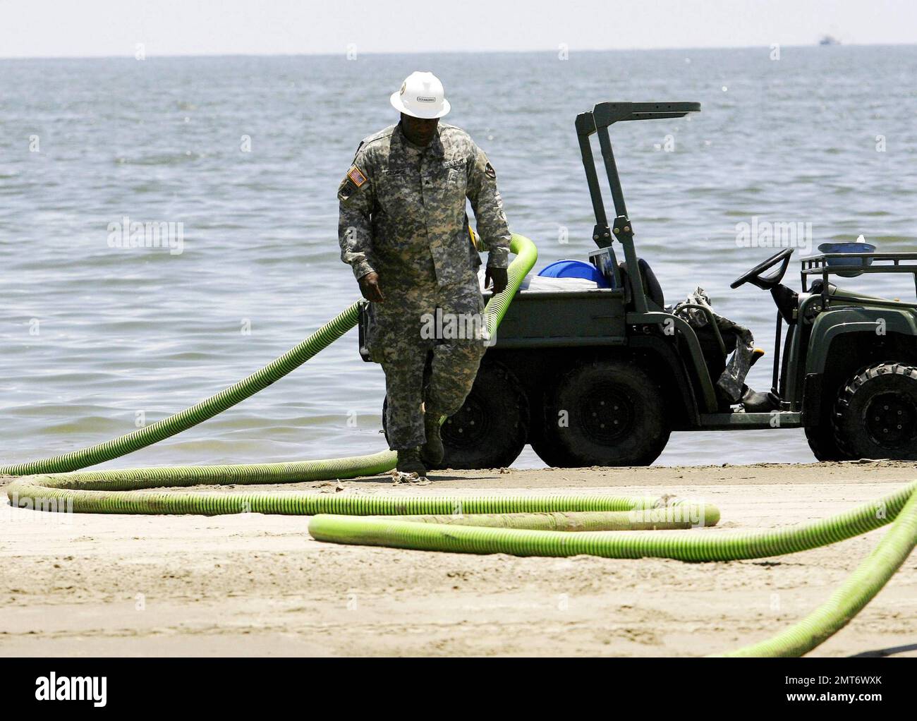 Inflatable barricades are installed by the National Guard on the beach ...