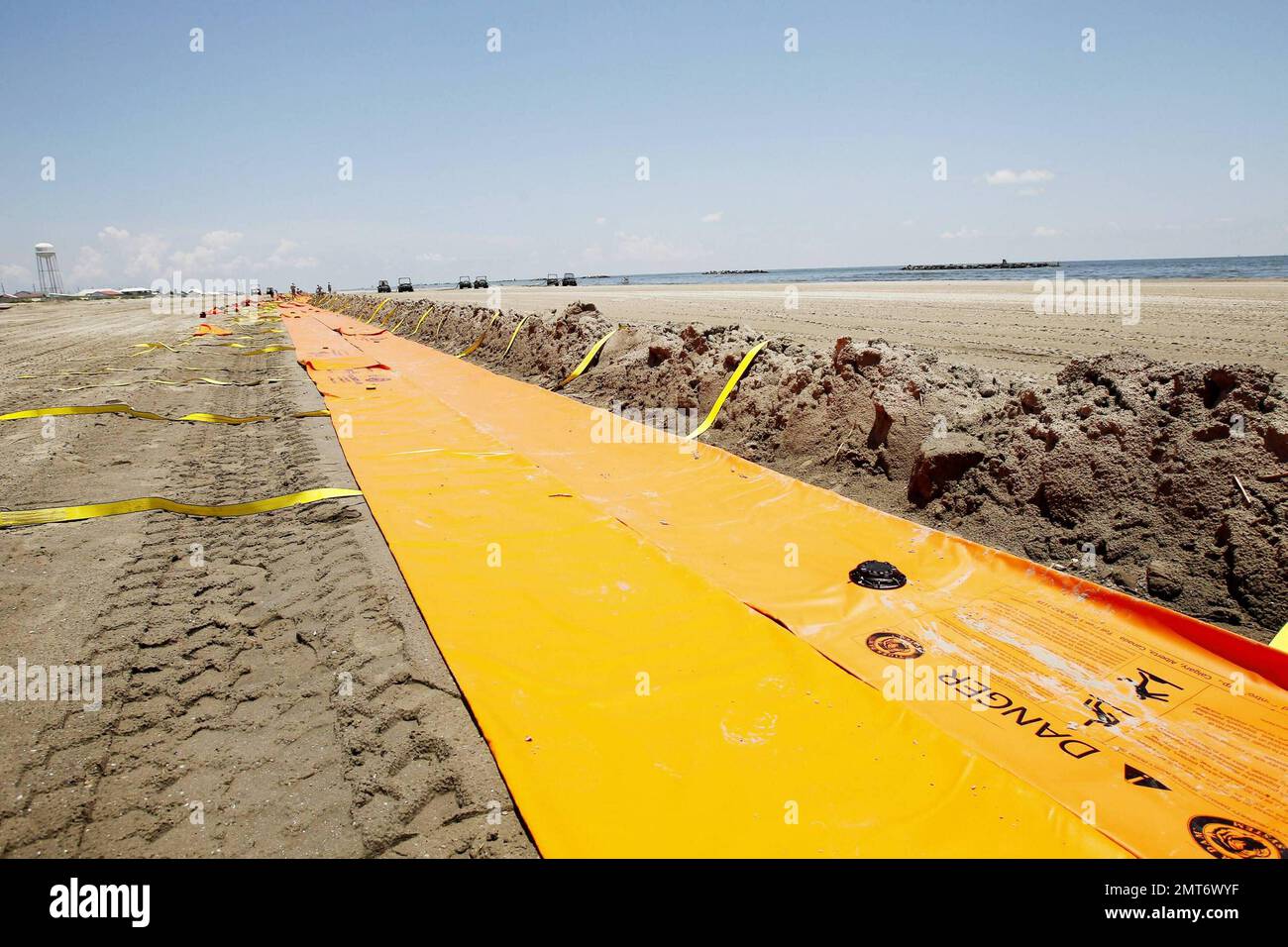 Inflatable barricades are installed by the National Guard on the beach ...
