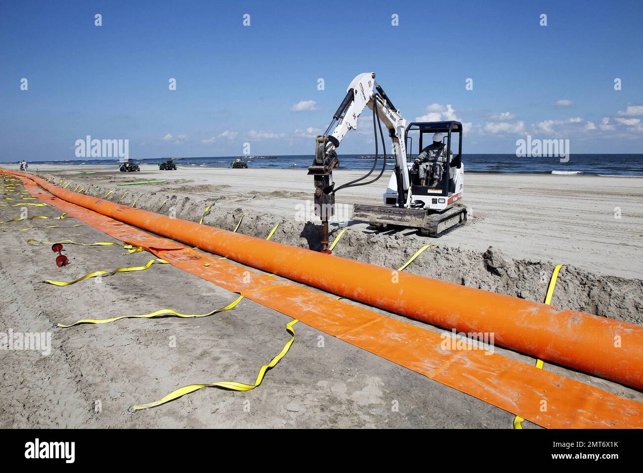 Inflatable barricades are installed by the National Guard on the beach ...