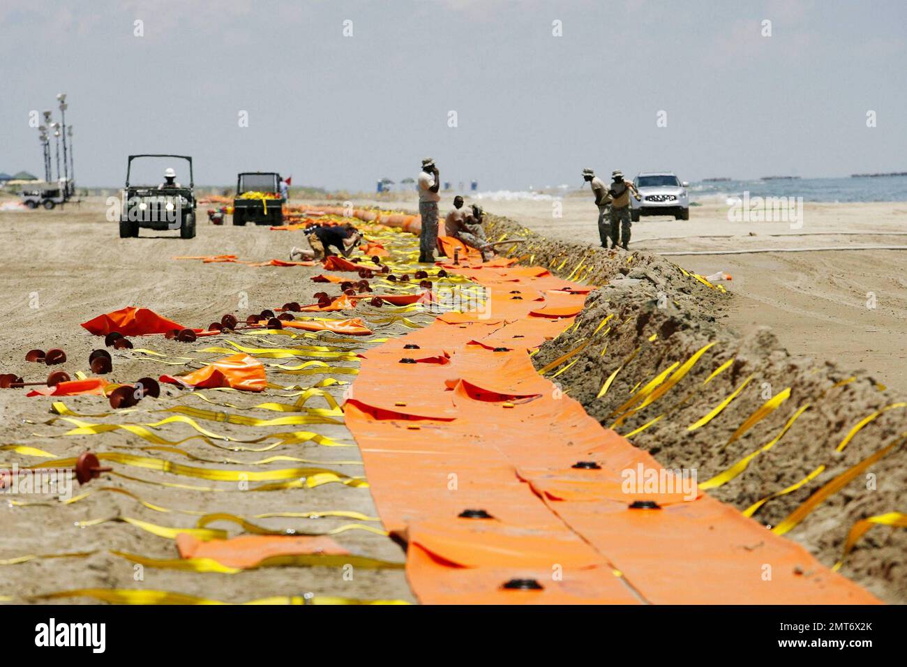 Inflatable barricades are installed by the National Guard on the beach ...