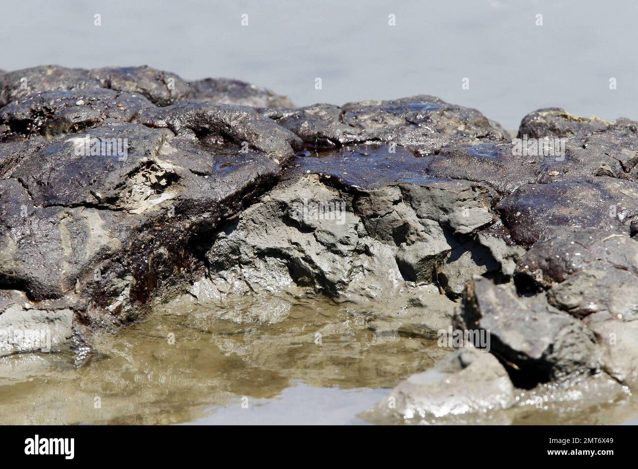 Oil on the beach is cleaned up in Grand Isle, Louisiana, the site of ...