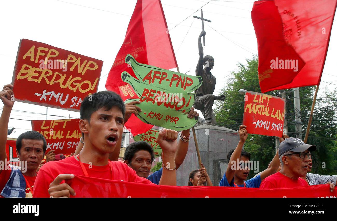 Protesters shout slogans as they arrive for a rally near the ...