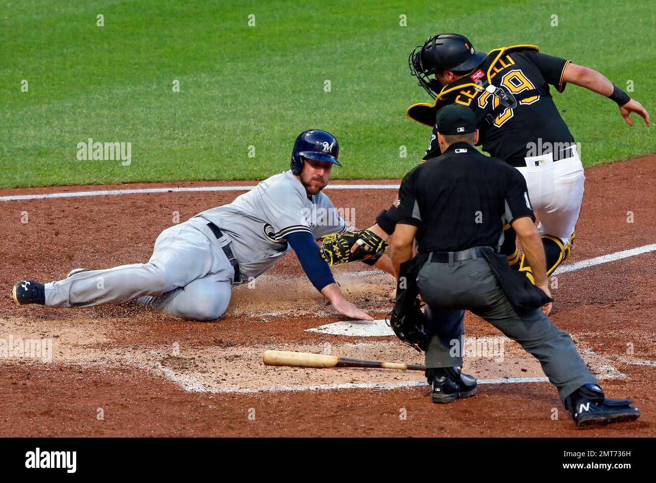 Milwaukee Brewers' Travis Shaw, left, slides safely under the swipe tag ...