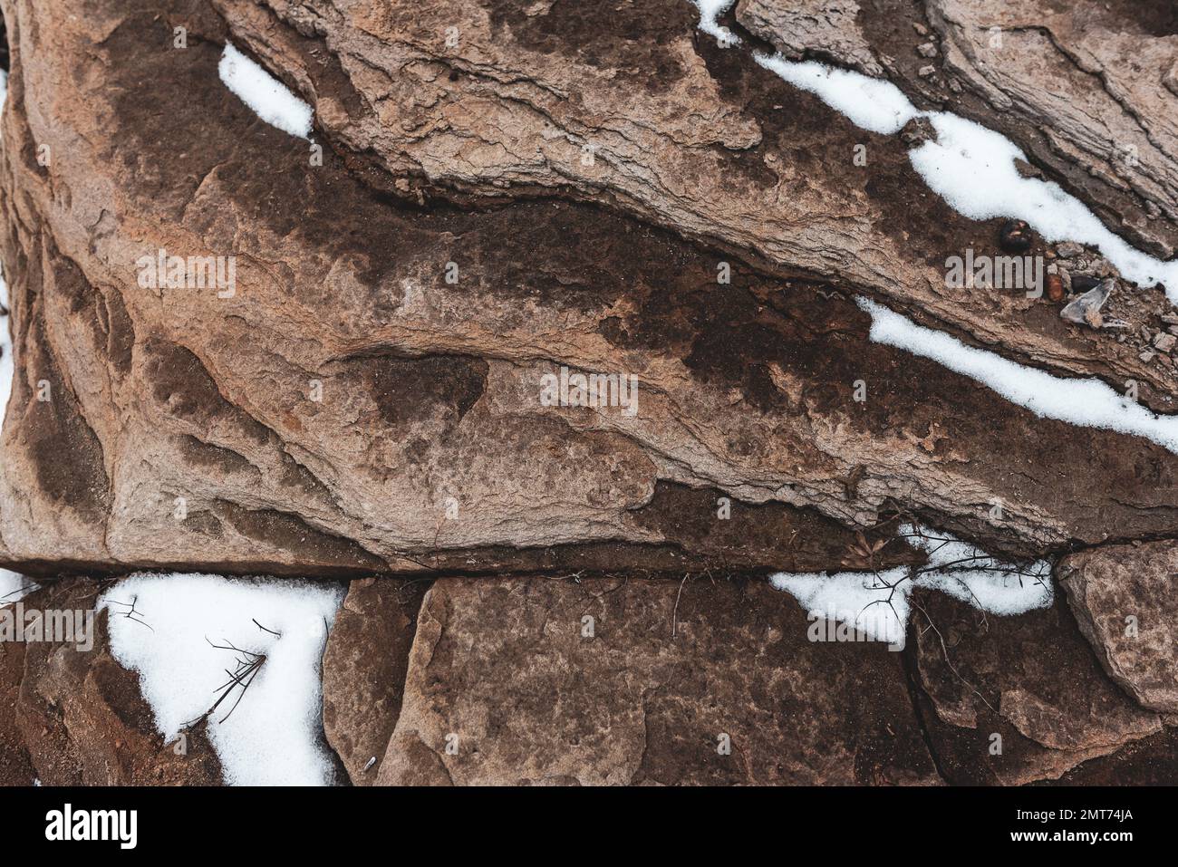 Photo of a stone rock with snow lying on it. Natural texture ...