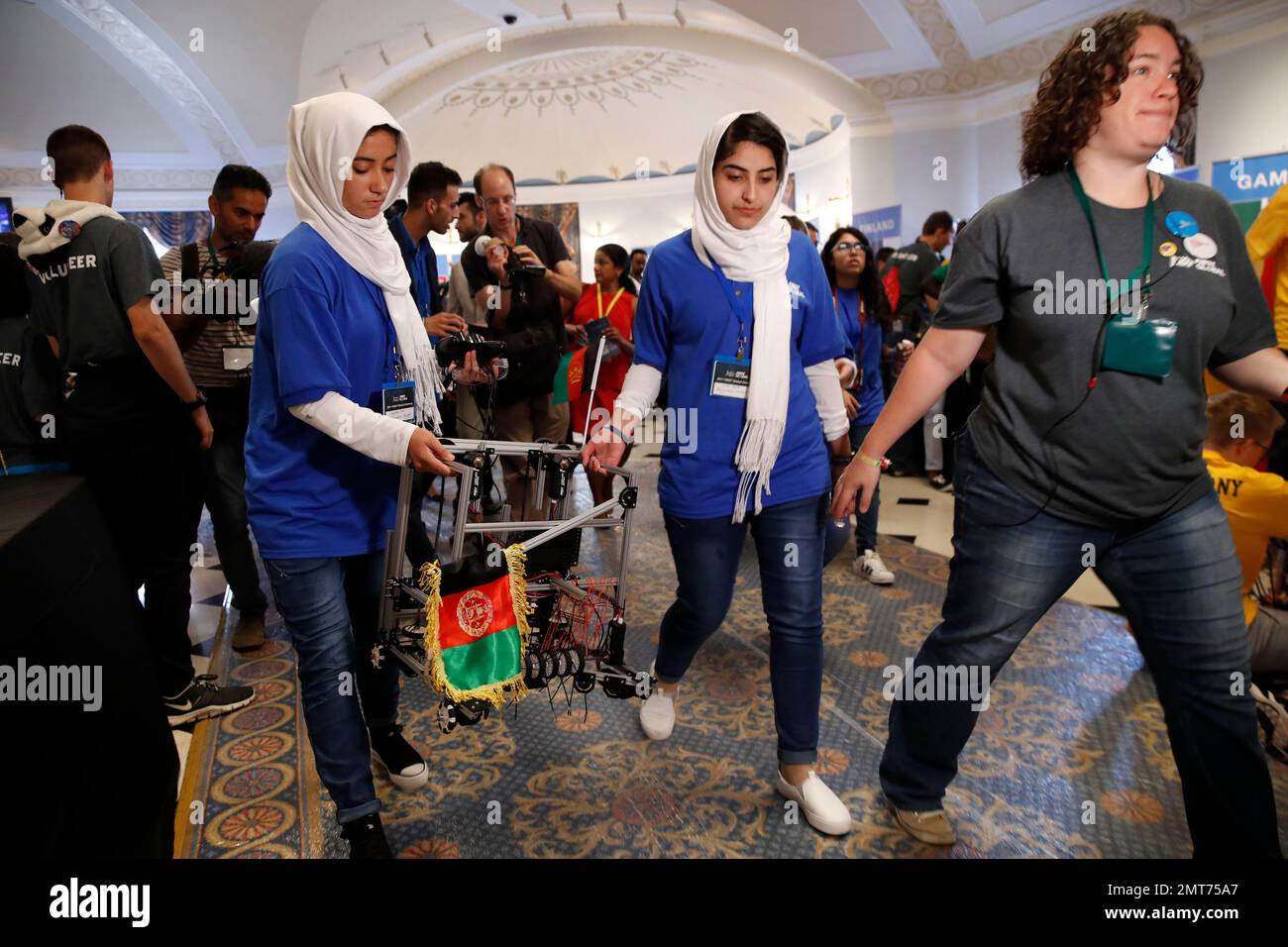 Rodaba Noori, left, and Lida Azizi, carry their teams robot to compete ...