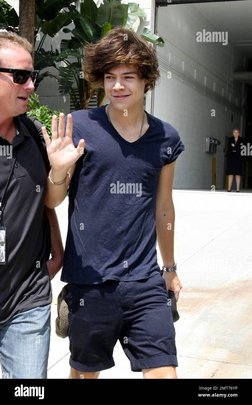 The boys from the British band 'One Direction' get mobbed as they leave ...