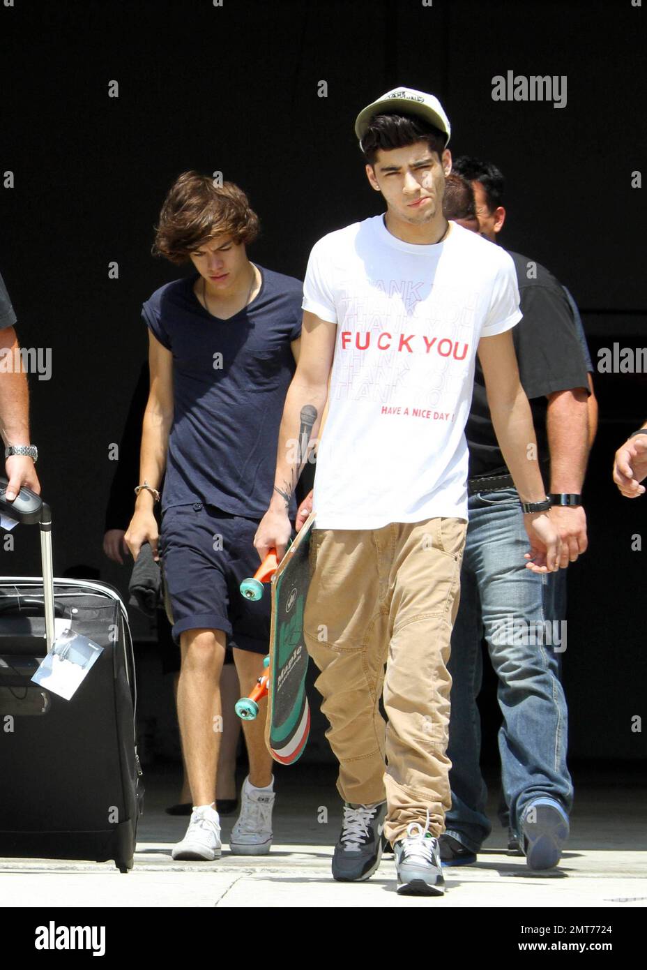 The boys from the British band 'One Direction' get mobbed as they leave ...