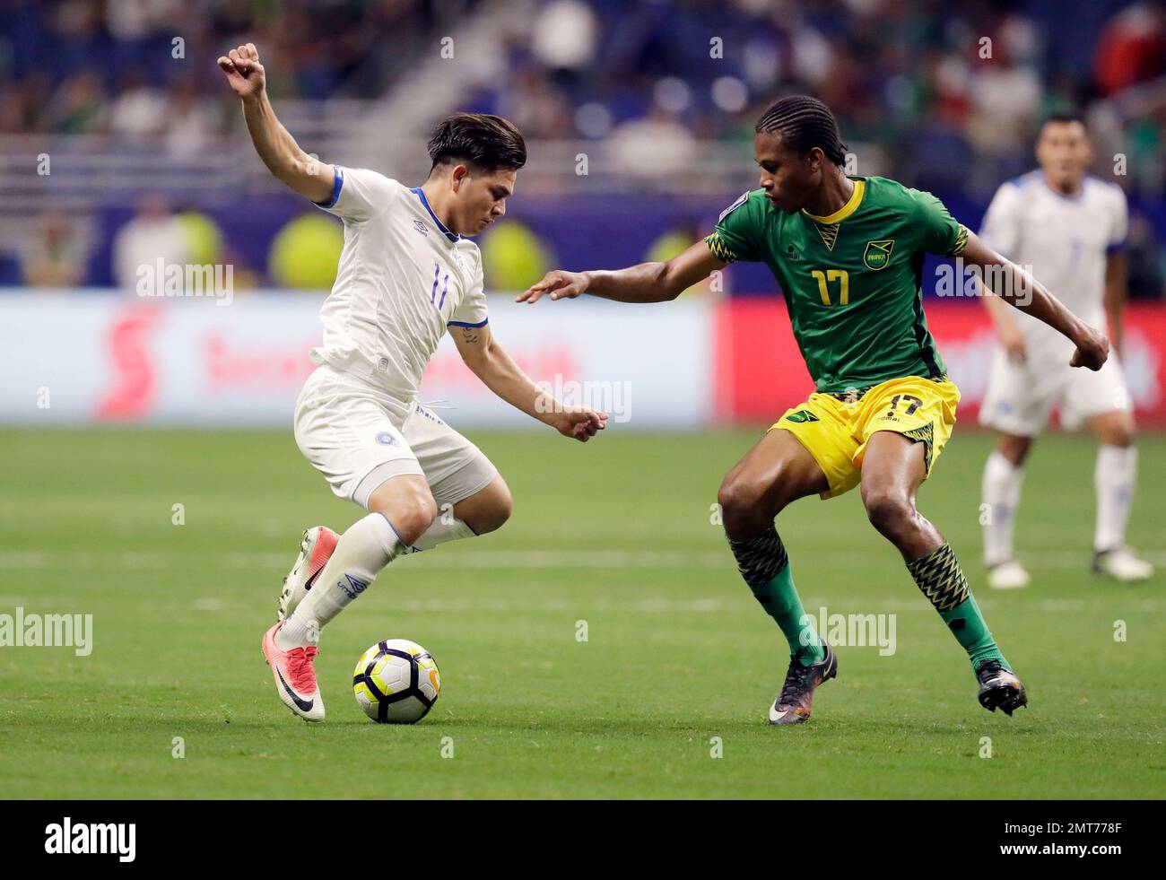 El Salvador's Rodolfo Zelaya (11) works the ball around Jamaica's Kevon ...