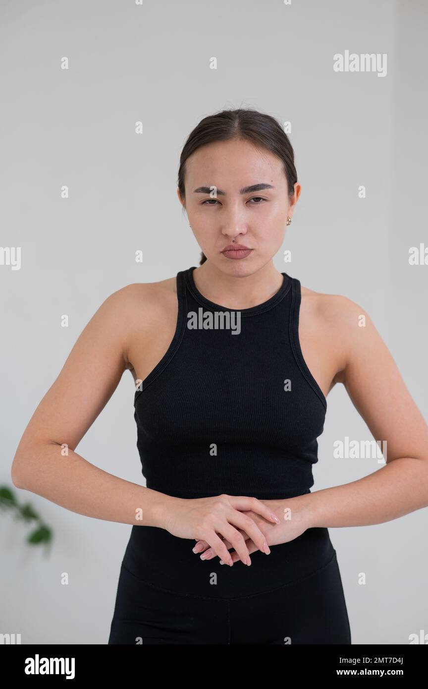 Portrait of a grimacing Asian woman on a white background Stock Photo ...