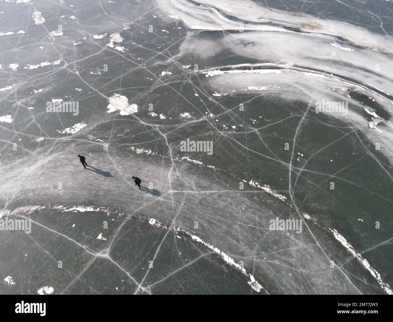 Aerial photos show people skating on the frozen Hun River in ...