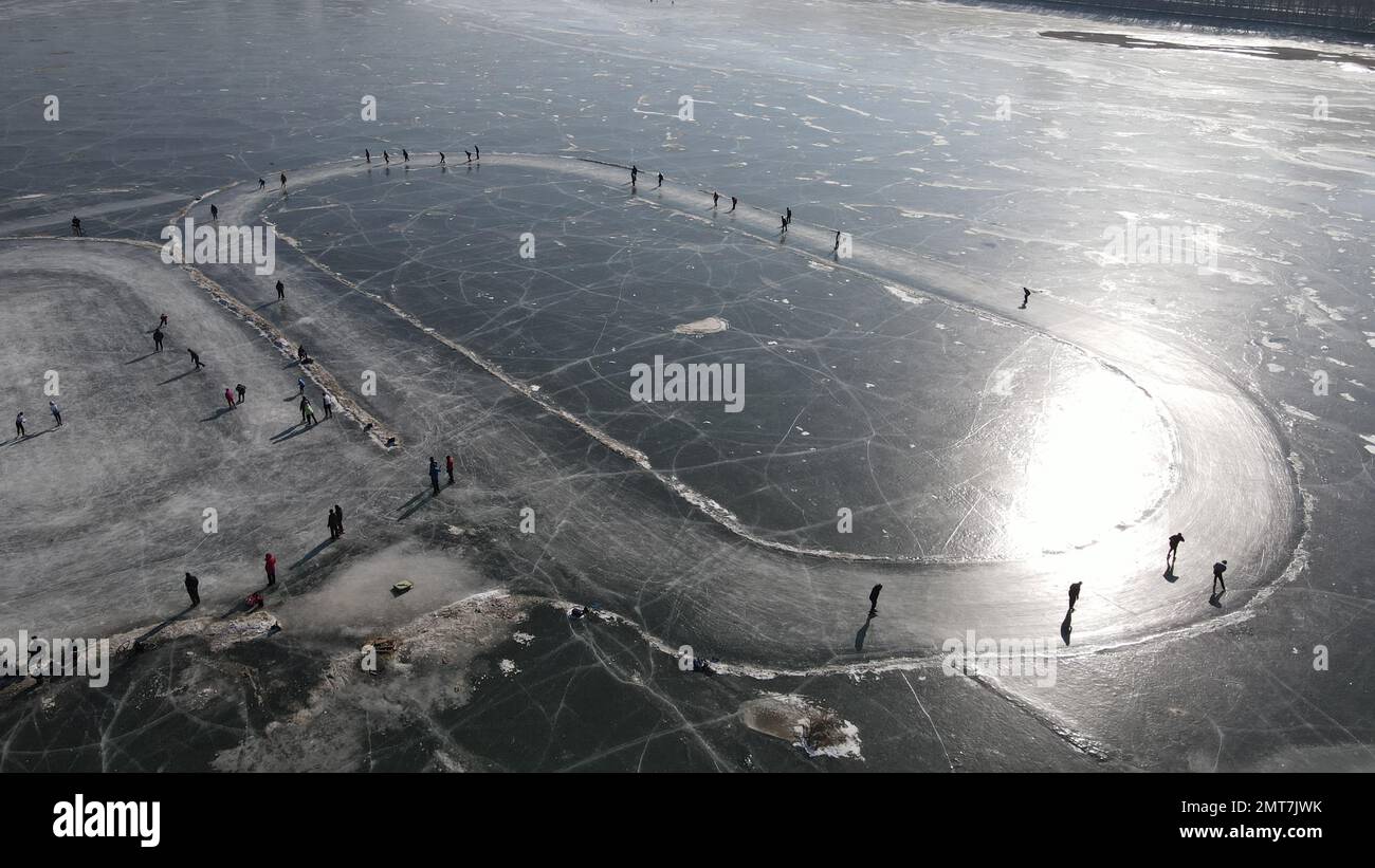 Aerial photos show people skating on the frozen Hun River in ...
