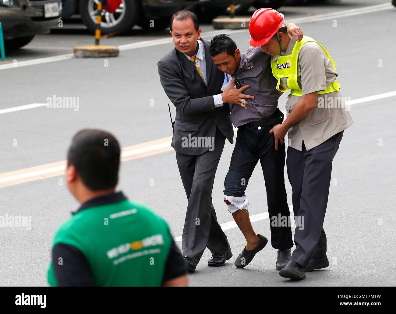 An "injured" hotel employee is helped by fellow employees during the ...