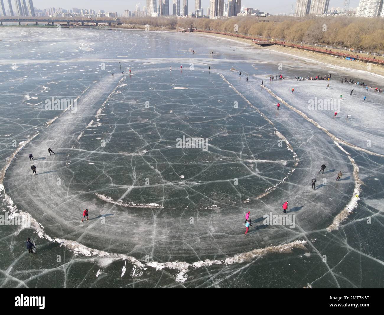 Aerial photos show people skating on the frozen Hun River in ...