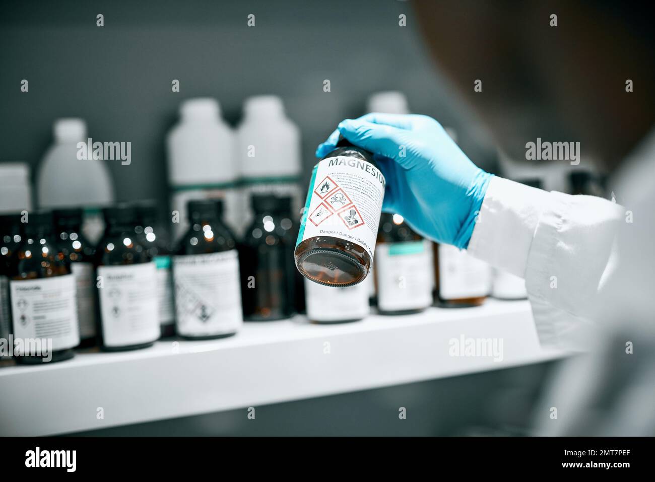 Chemical, magnesium solution and chemistry worker hands in a laboratory ...