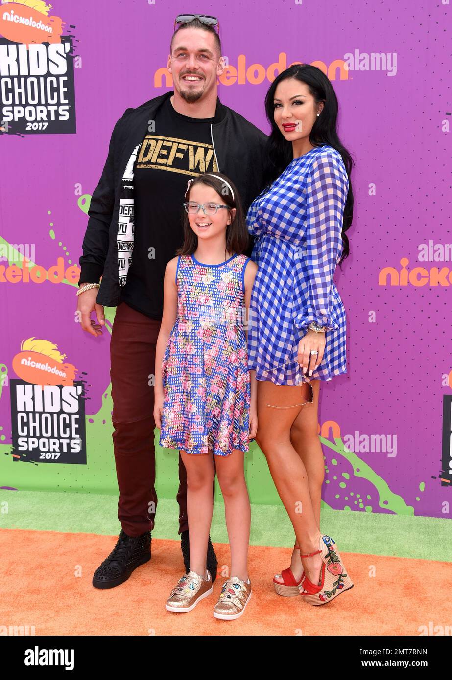 NFL football player Derek Wolfe, of the Denver Broncos, from left, Abigail Burrows and Tatum ...