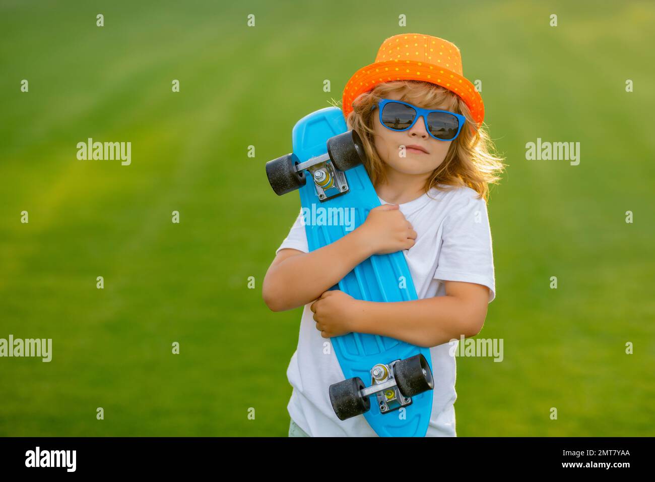 Summer kids. Childhood and fashion. Cute child with skateboard on ...