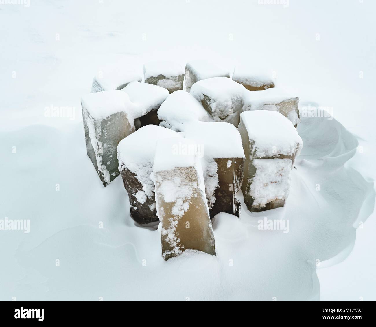 Pillars of ice for defrosting and eating stands covered with snow on ...