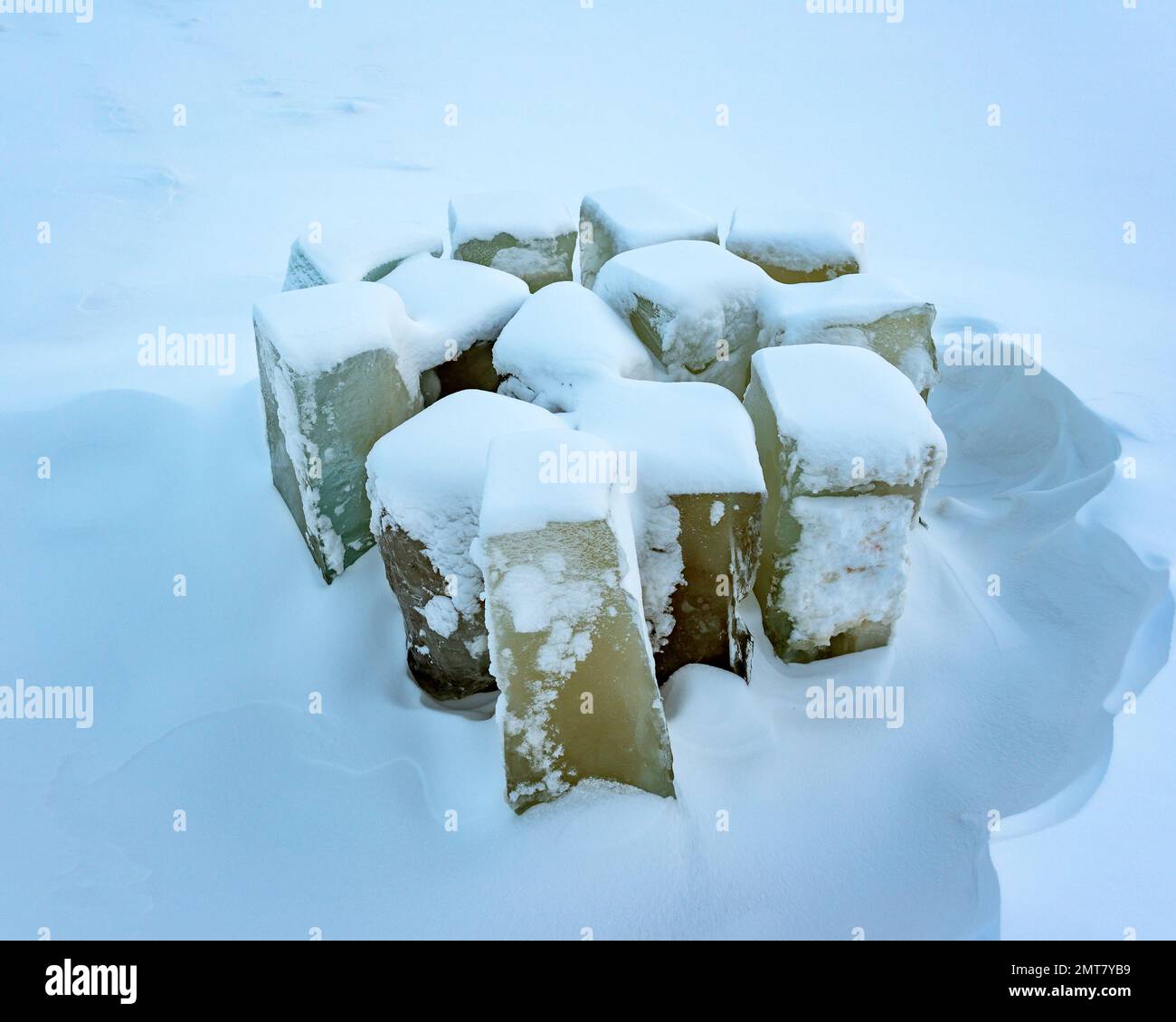 Pillars of ice for defrosting and eating stands covered with white snow ...