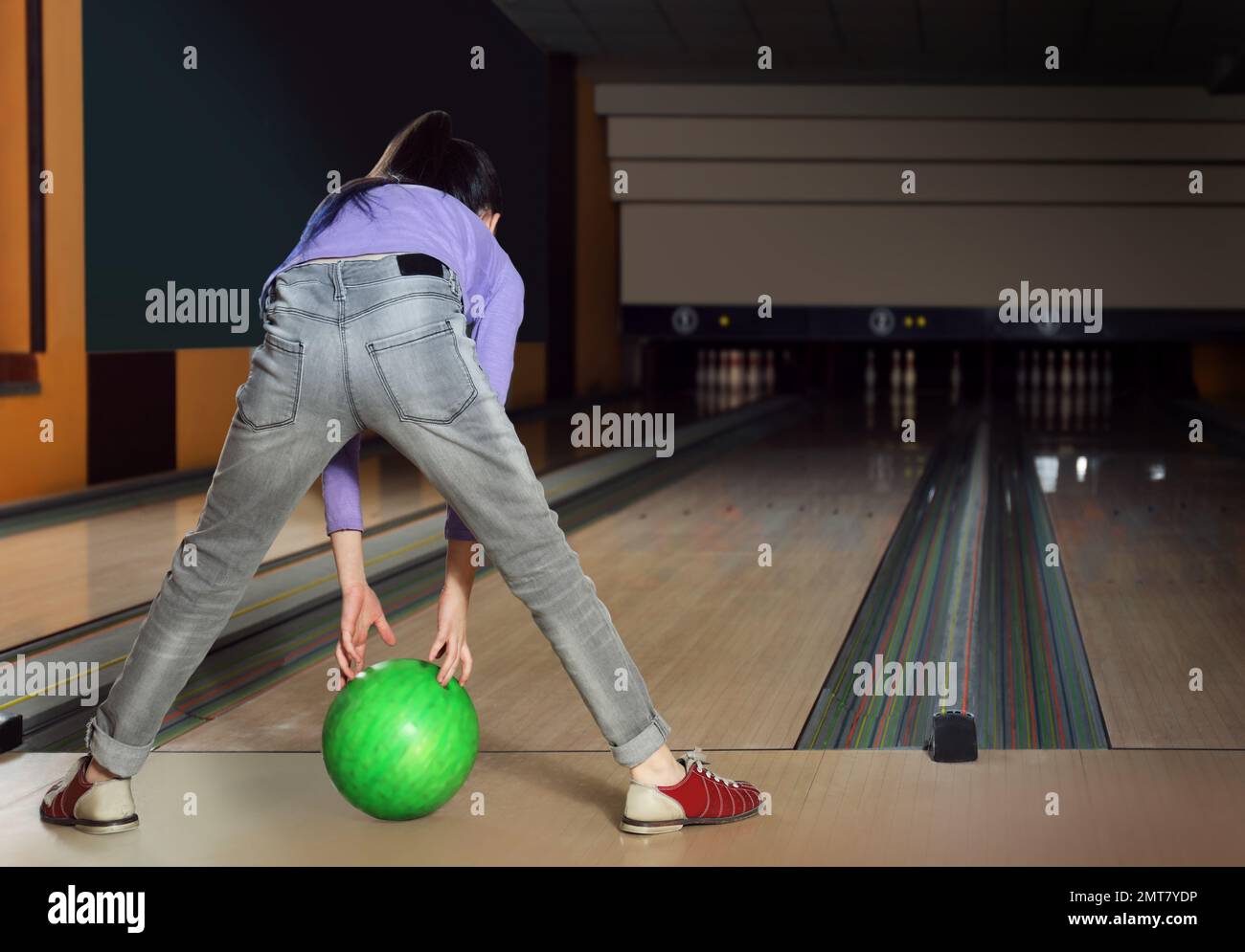 Girl throwing ball in bowling club, back view Stock Photo - Alamy
