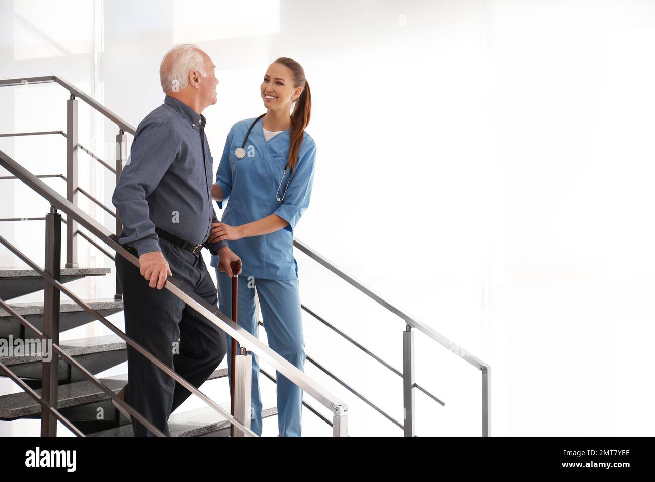Doctor helping senior patient in modern hospital Stock Photo - Alamy