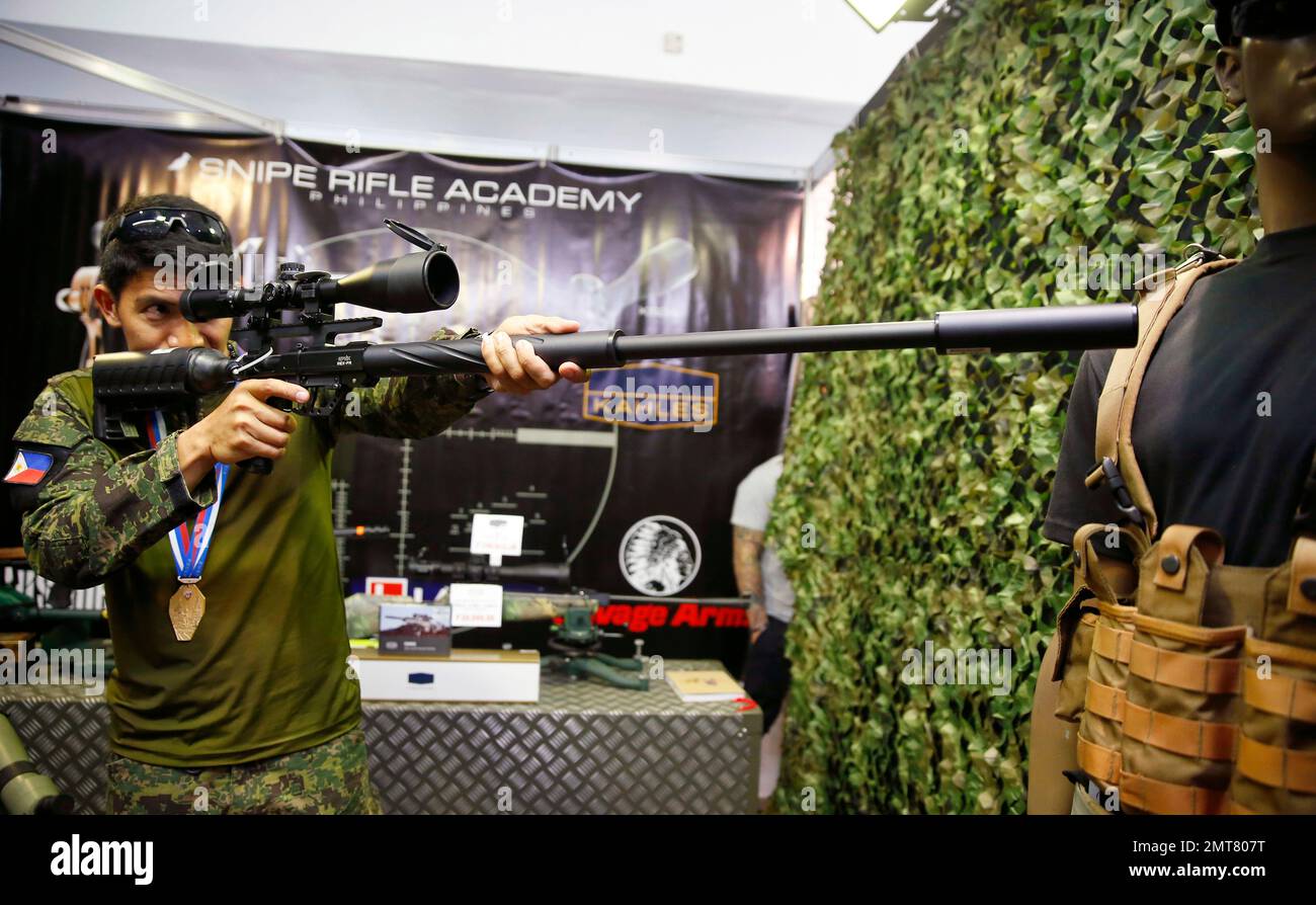 Philippine Army Sergeant Ariel Taganait checks a sniper's rifle during ...