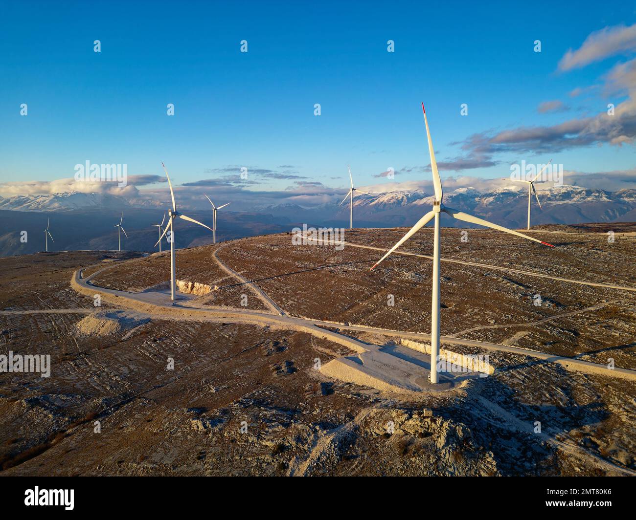 Windmills on the hills during sunset. Renewable energy, green energy ...