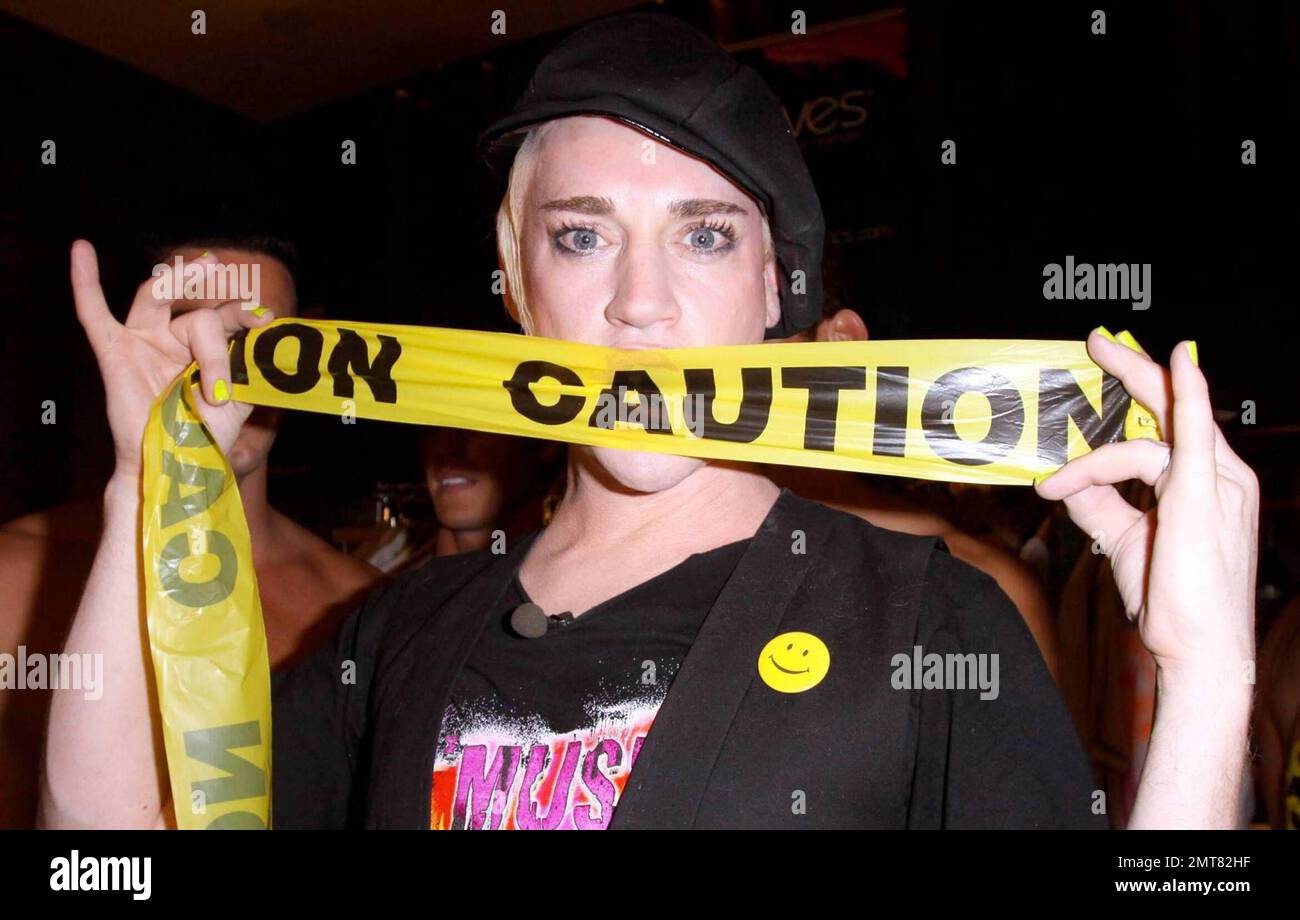 Pamela Anderson wears a baywatch bikini, accessorized with caution tape ...