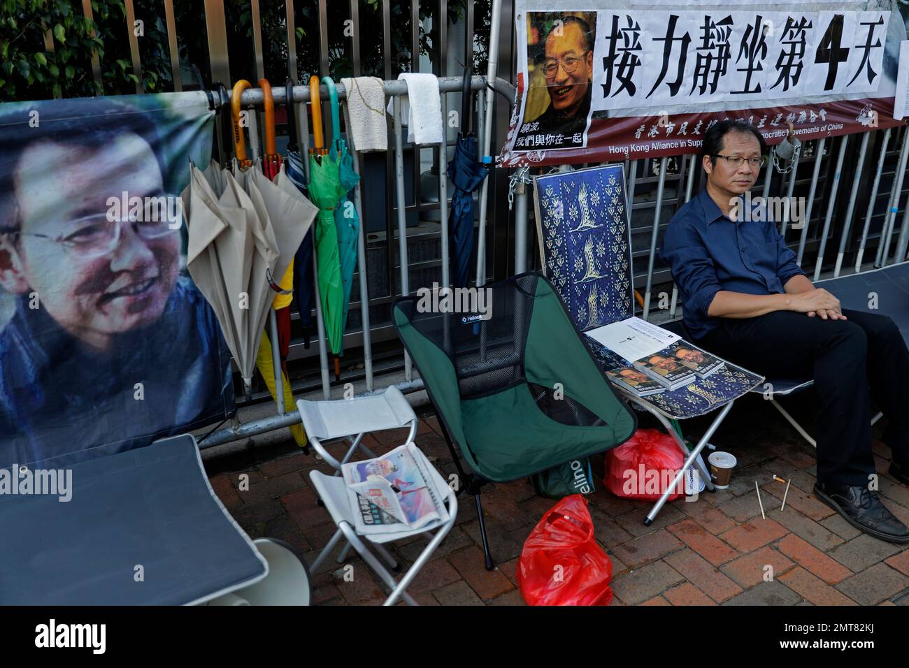 A protester displays pictures of jailed Chinese Nobel Peace laureate ...