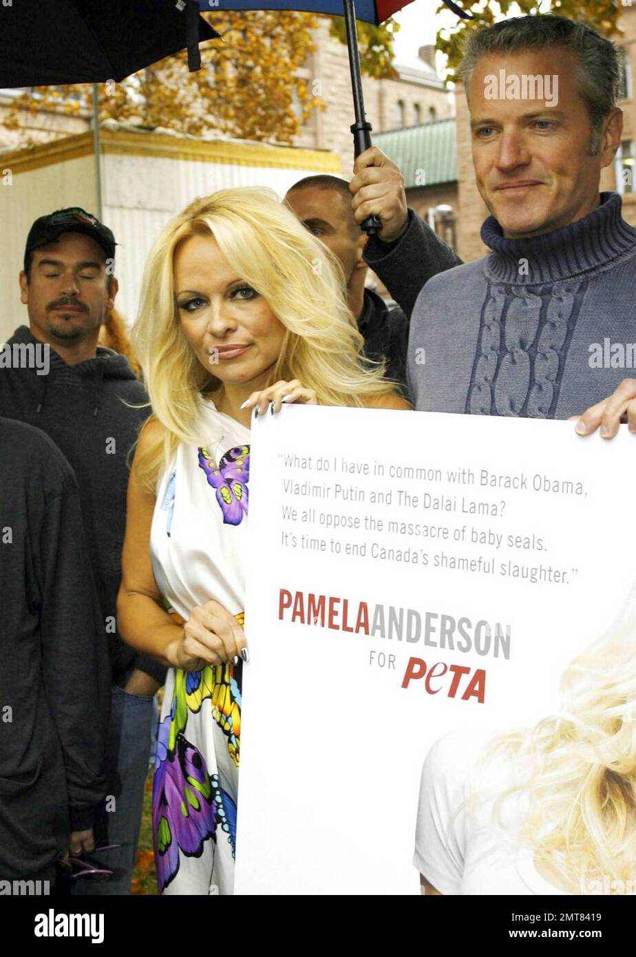 Pamela Anderson wears a colorful spring-like dress on a very dreary day ...