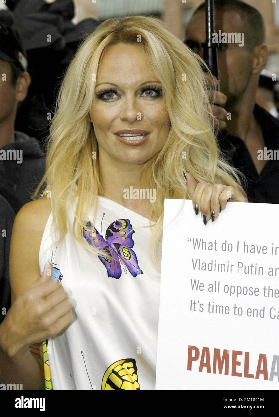 Pamela Anderson wears a colorful spring-like dress on a very dreary day ...