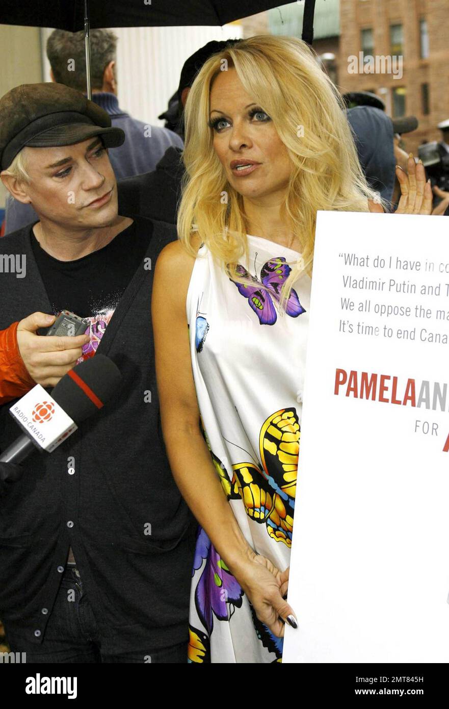 Pamela Anderson wears a colorful spring-like dress on a very dreary day ...