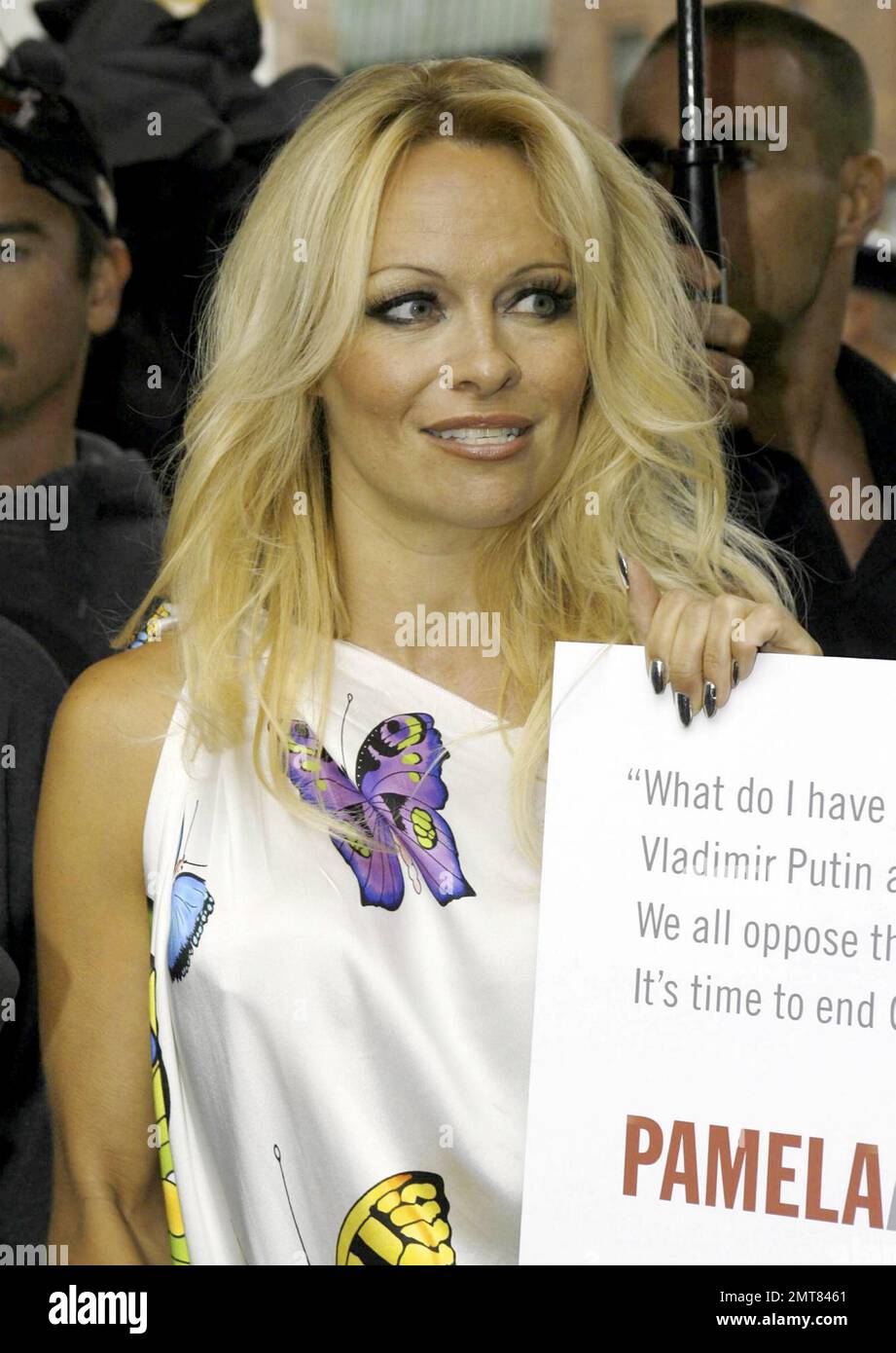Pamela Anderson wears a colorful spring-like dress on a very dreary day ...