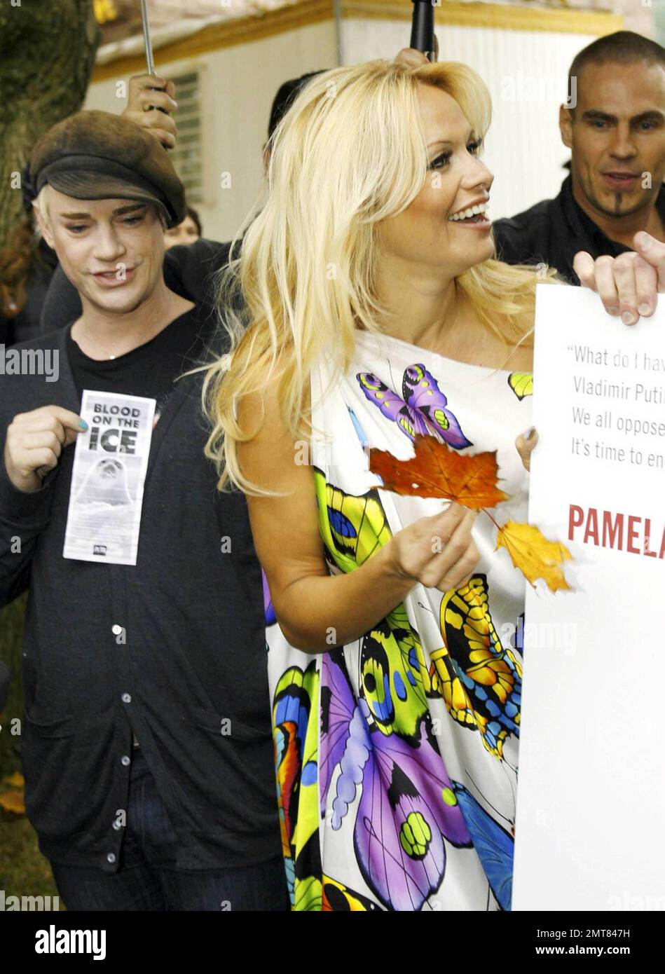 Pamela Anderson wears a colorful spring-like dress on a very dreary day ...