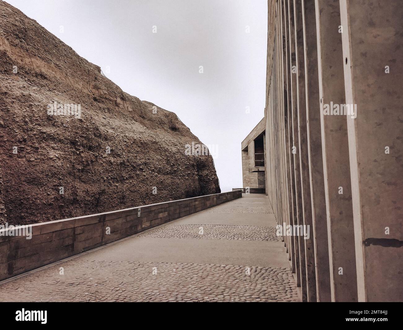 A beautiful shot of a walking path between a cliff and a building Stock ...