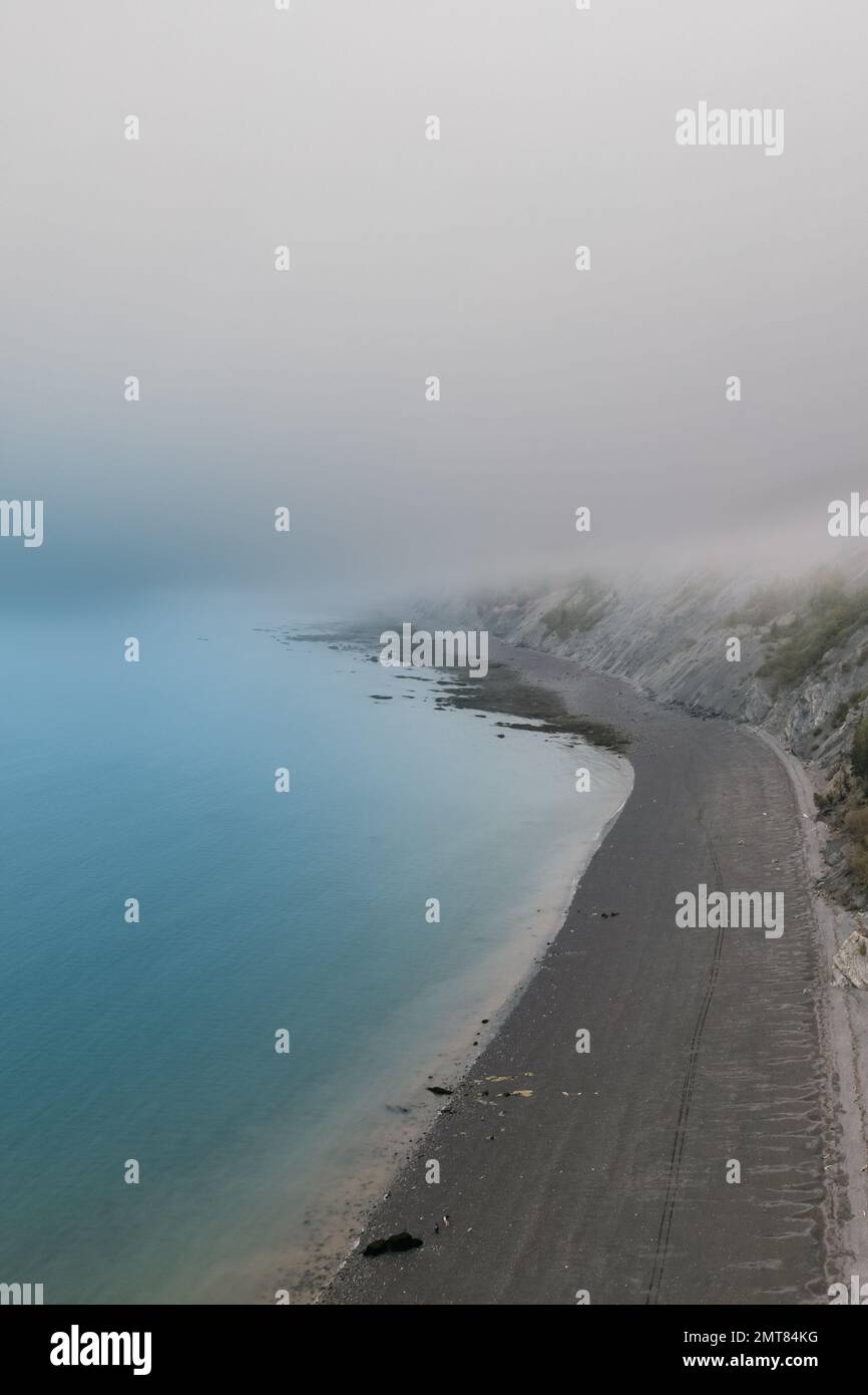A vertical shot of sea water covering an empty sandy beach Stock Photo ...