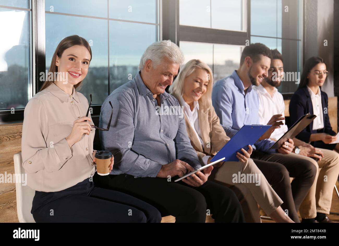 People waiting for job interview in office hall Stock Photo - Alamy
