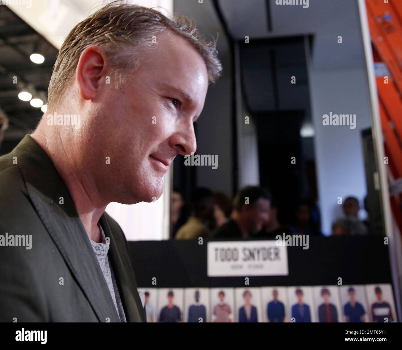 Designer Todd Snyder pauses by a model board showing the clothing his ...